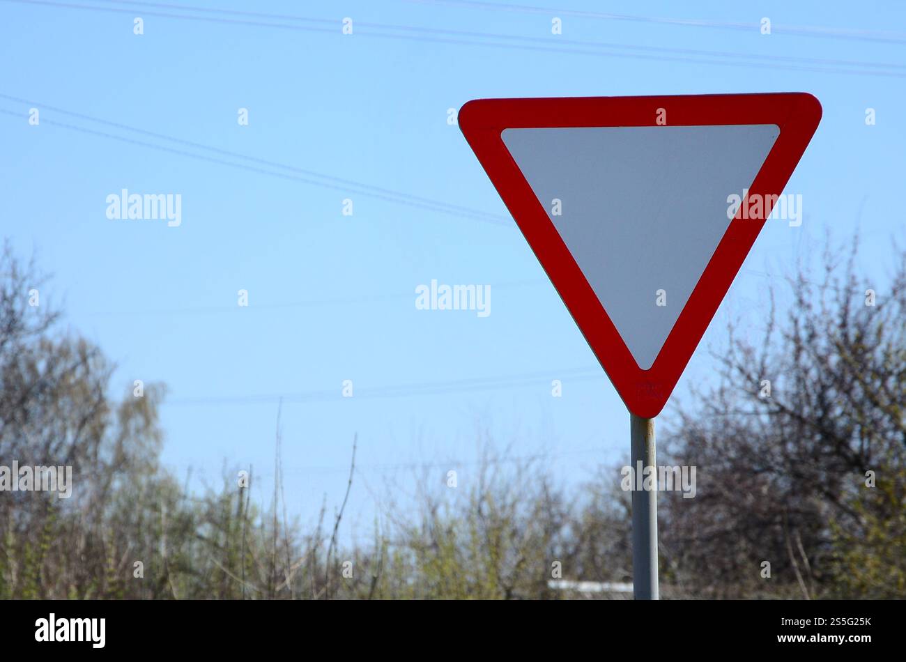 Traffic sign in the form of a white triangle. Give way Stock Photo - Alamy
