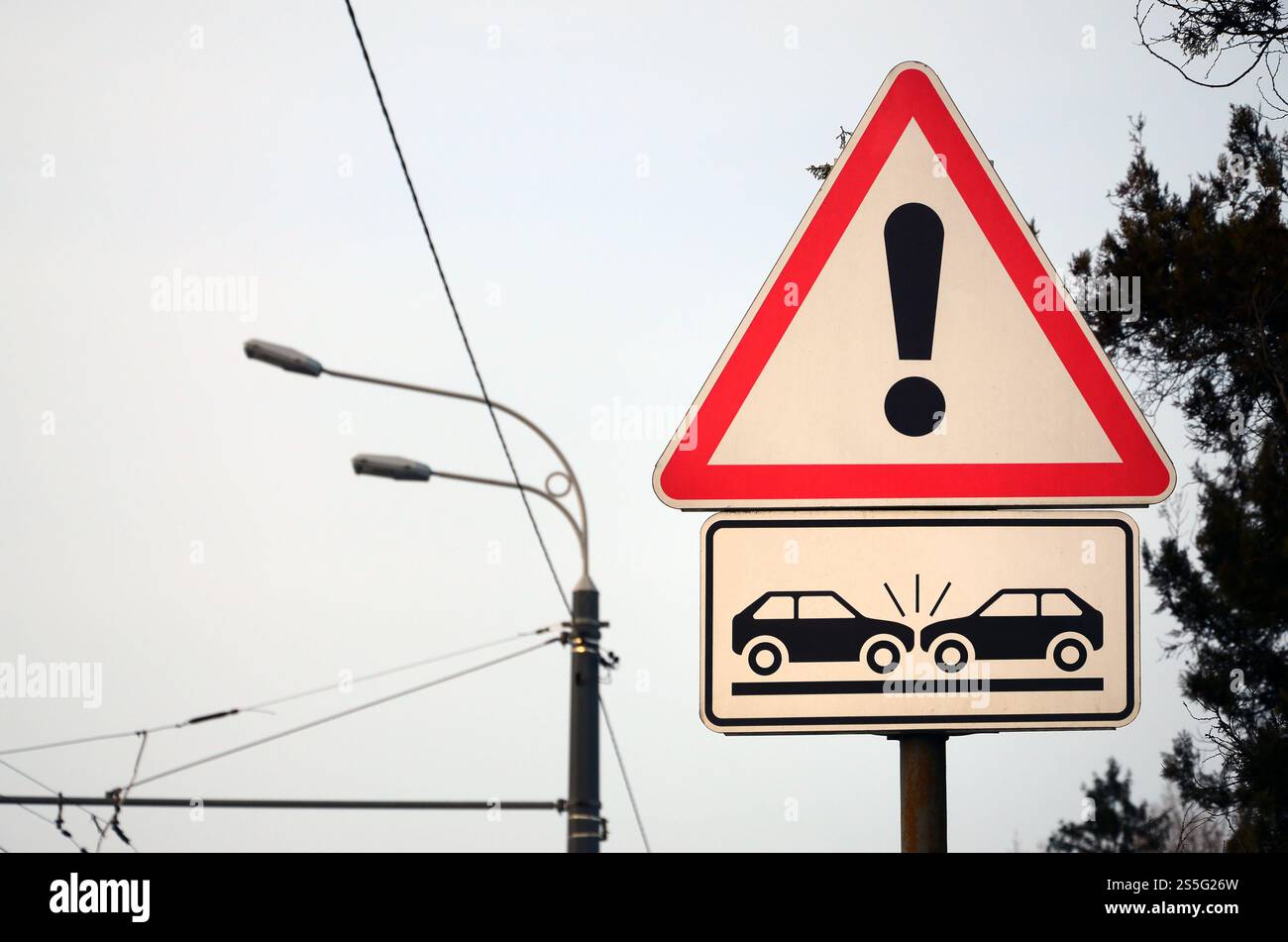 High risk of collision. A road sign with an exclamation point and two ...