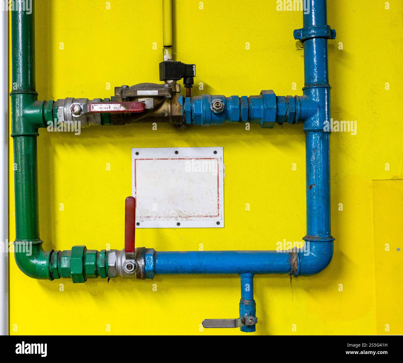 pipes and taps of automatic fire extinguishing system on the yellow ...