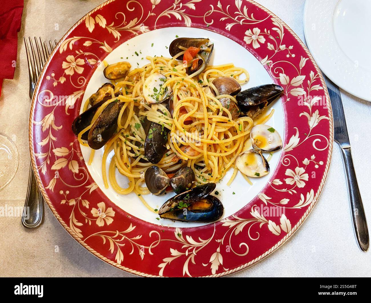 top view of spaghetti with mussels and clams on plate in local italian ...