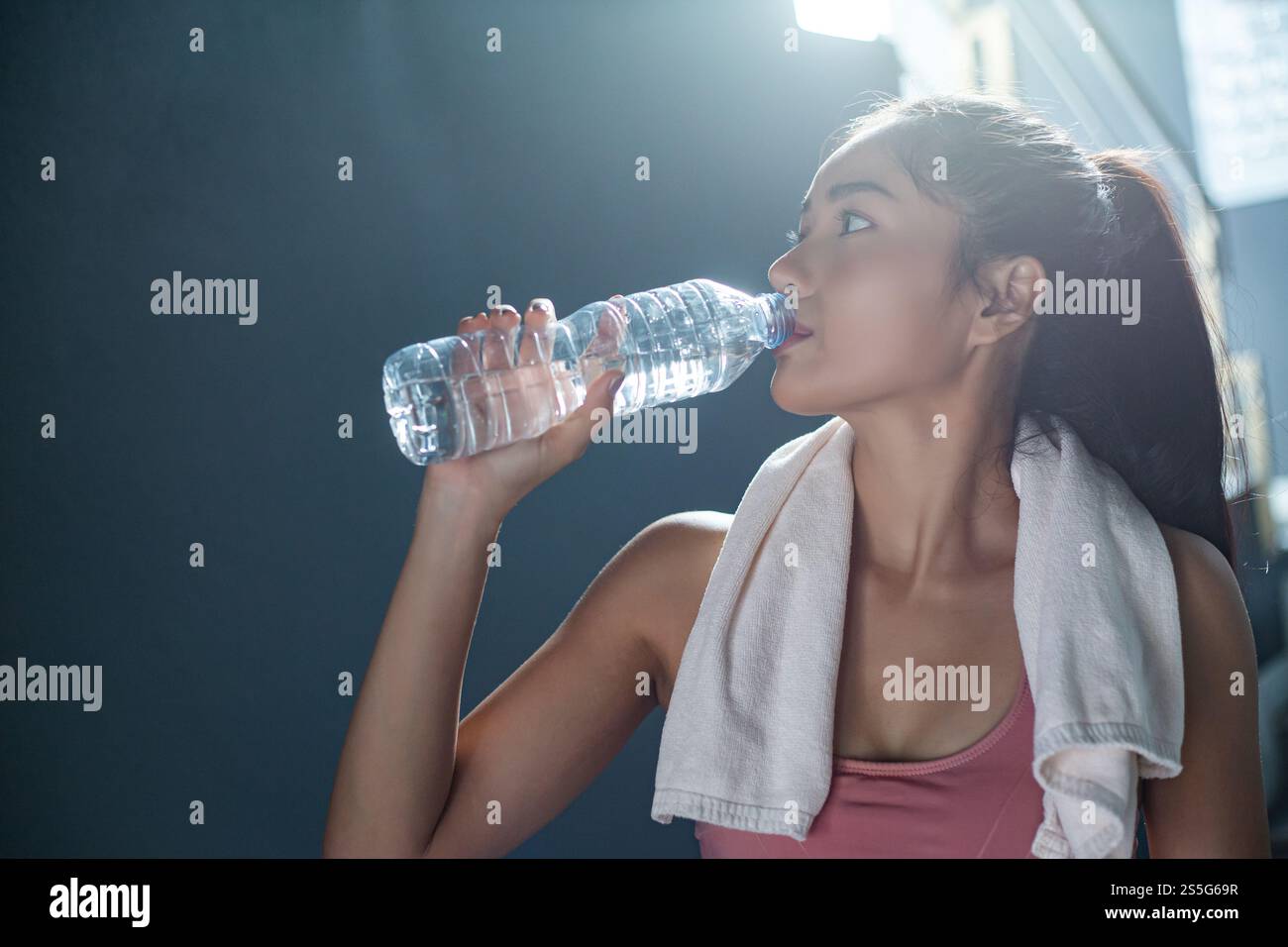 Women after exercise drink water from bottles and handkerchiefs in the ...