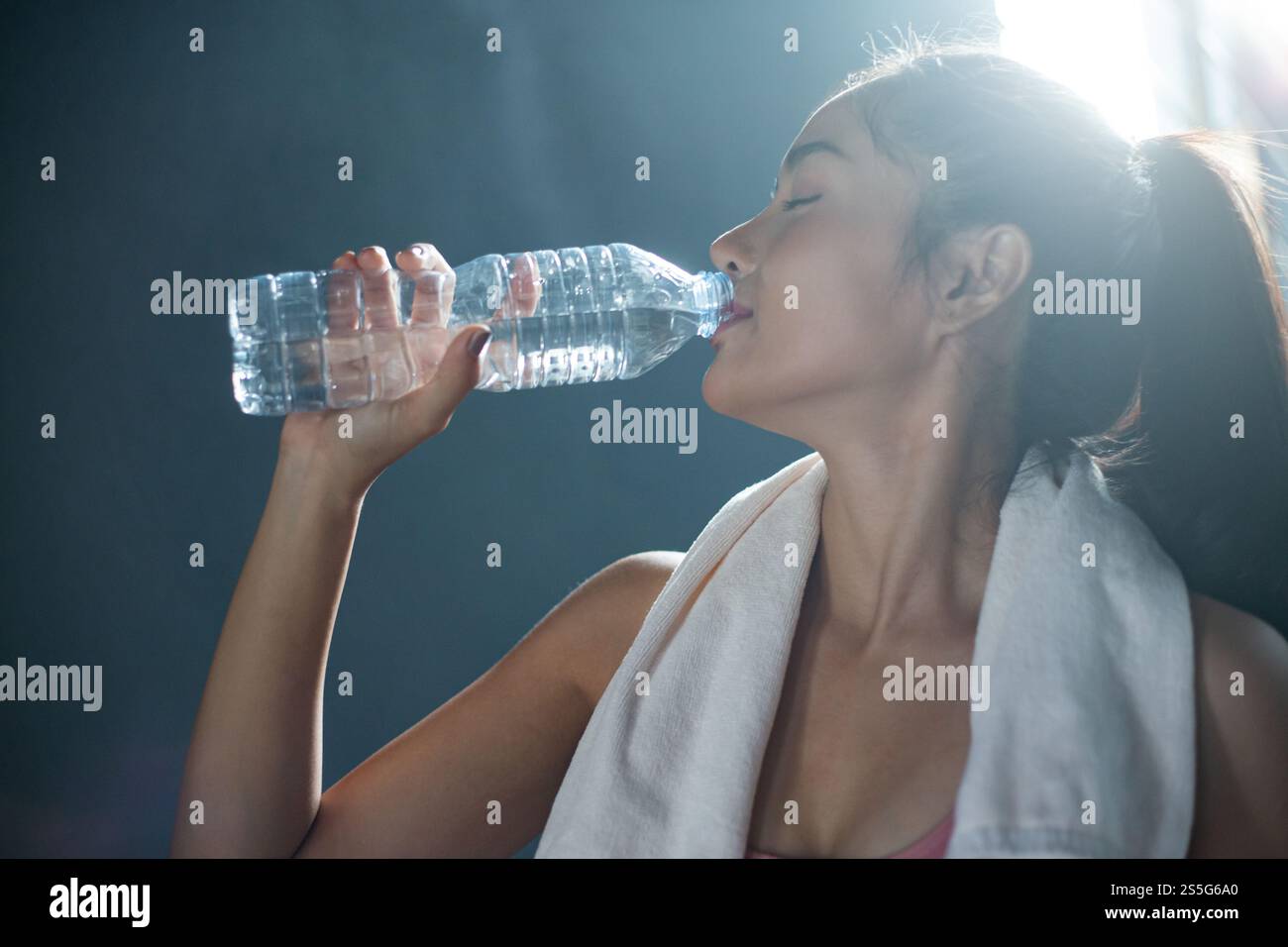 Women after exercise drink water from bottles and handkerchiefs in the ...