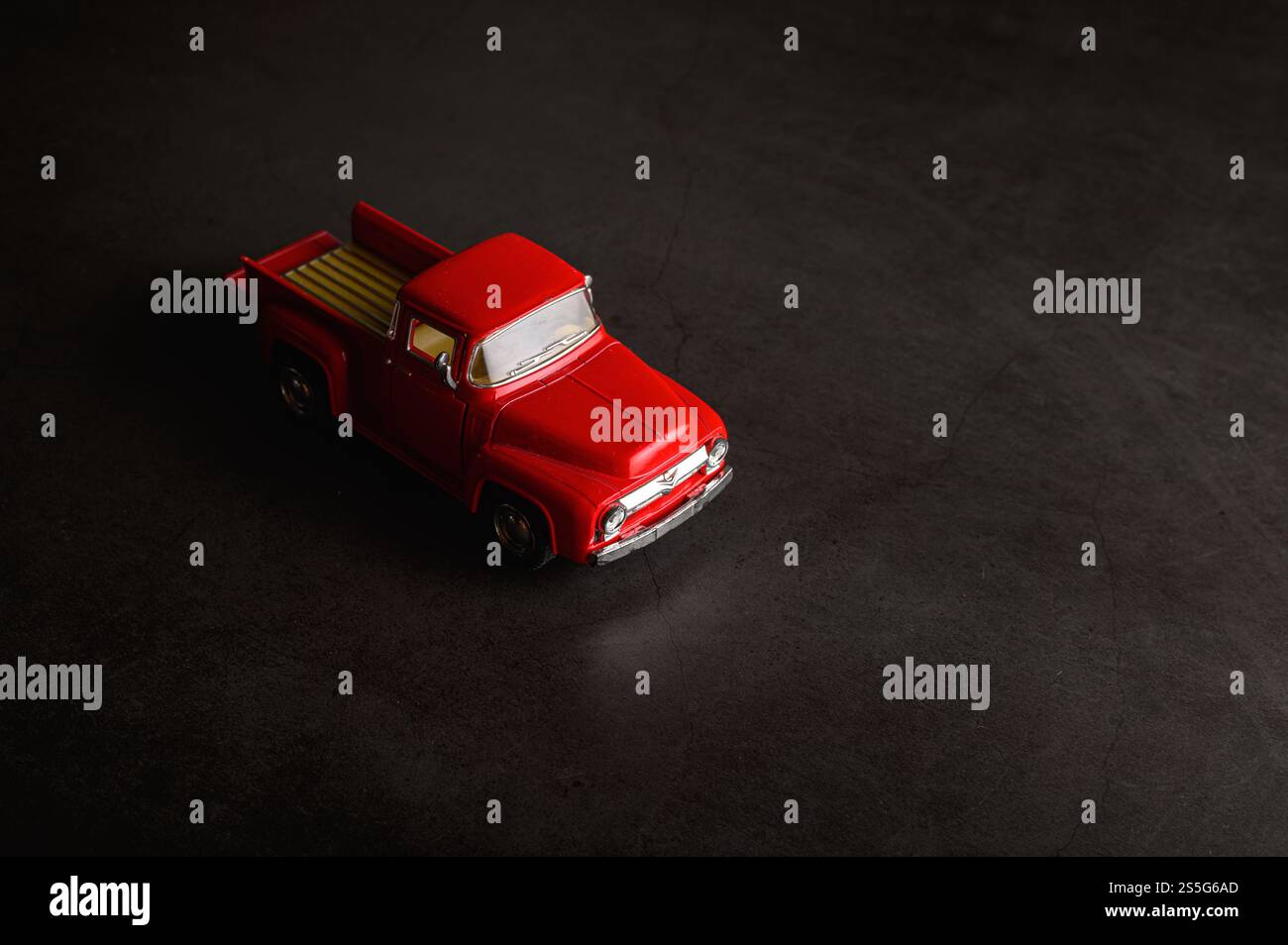 Red pickup model on the black floor Stock Photo - Alamy