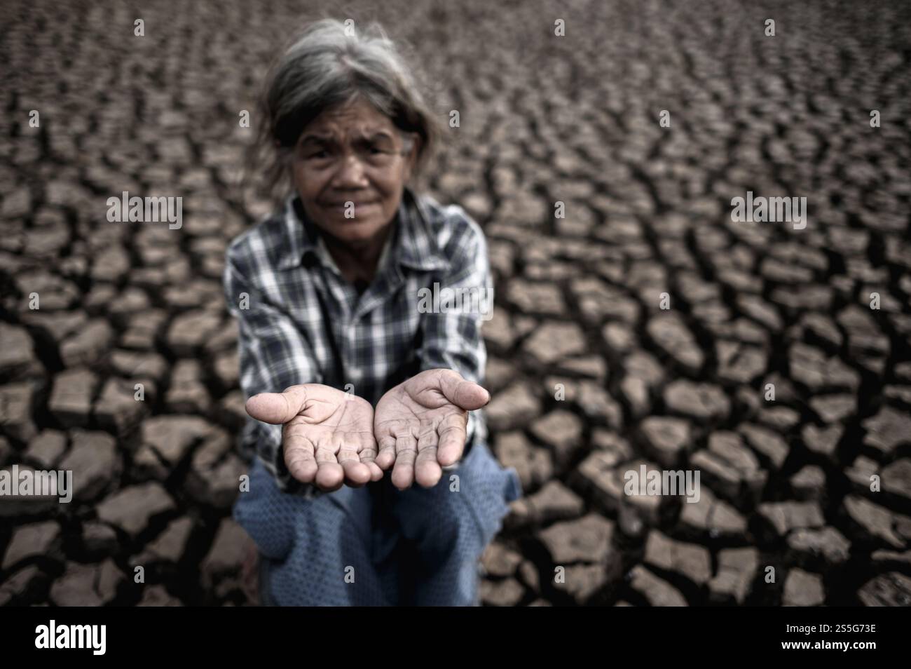 Elderly women make hands to get rainwater in dry weather, global ...
