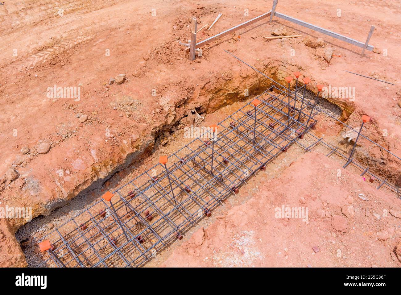 Construction workers prepare trench with reinforced rebar for ...