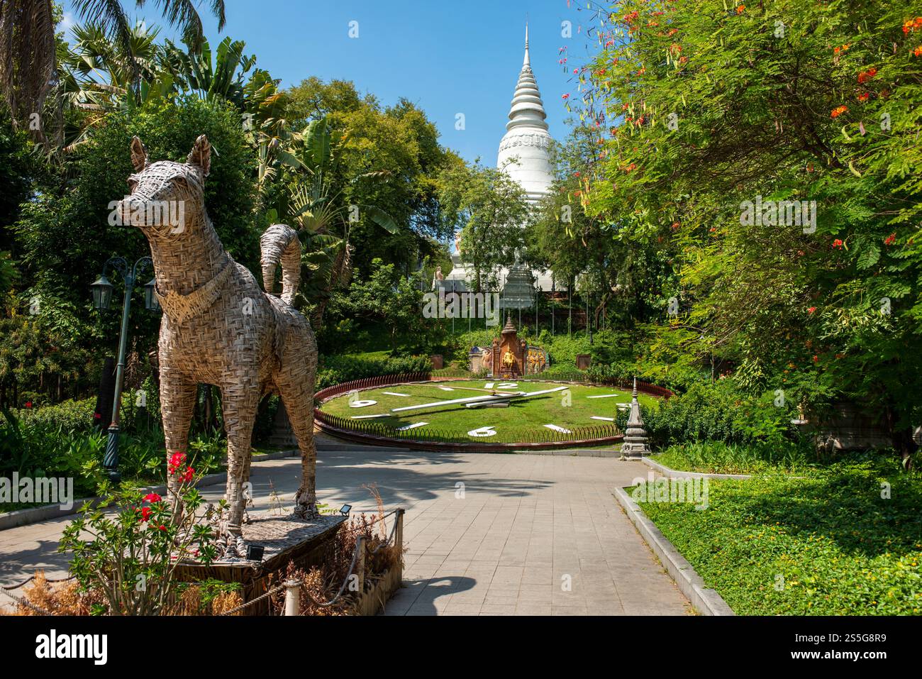 Sculpture of a dog and lawn clock at Wat Phnom, Phnom Penh, Cambodia ...