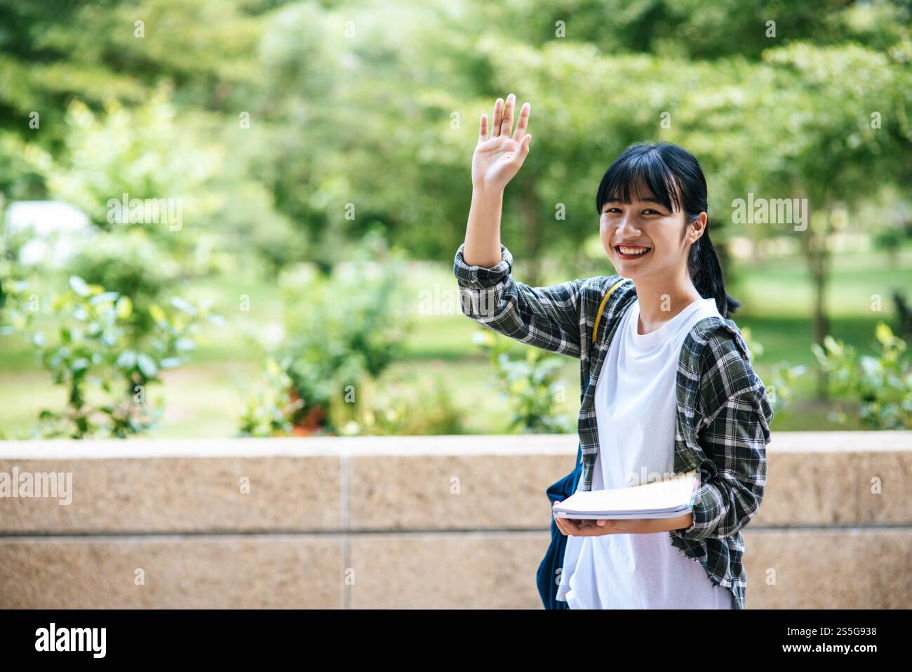 Female students stand on the stairs and hold books Stock Photo - Alamy