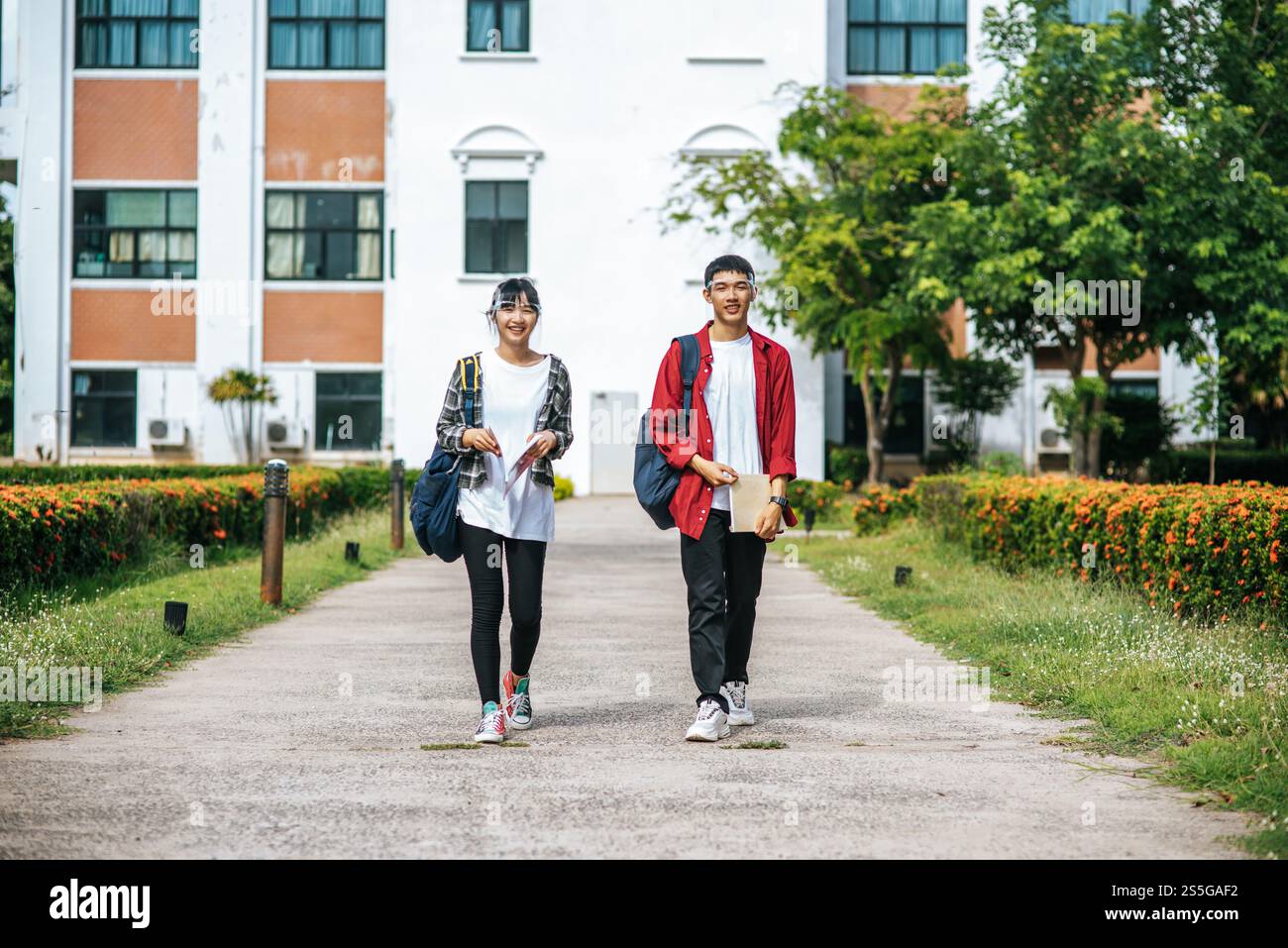 Male and female students wear a face Chill and stand in front of the ...