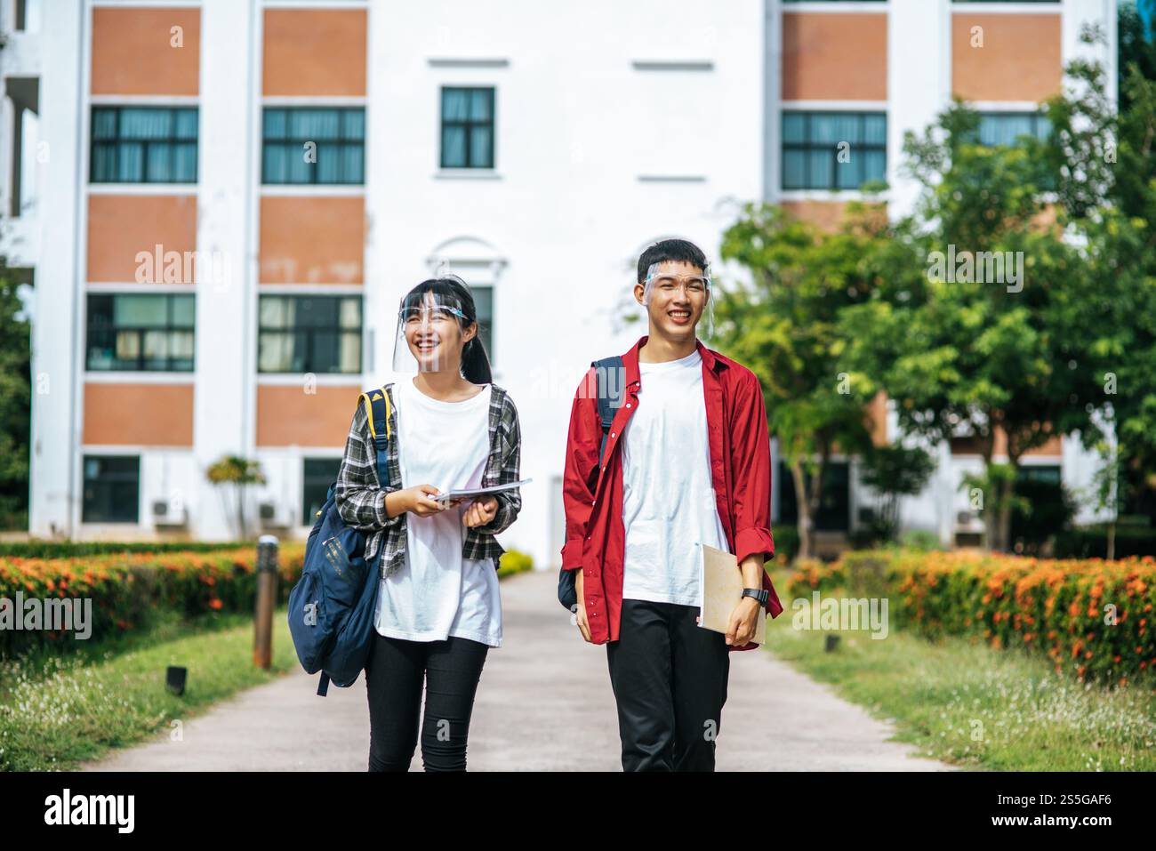 Male and female students wear a face Chill and stand in front of the ...
