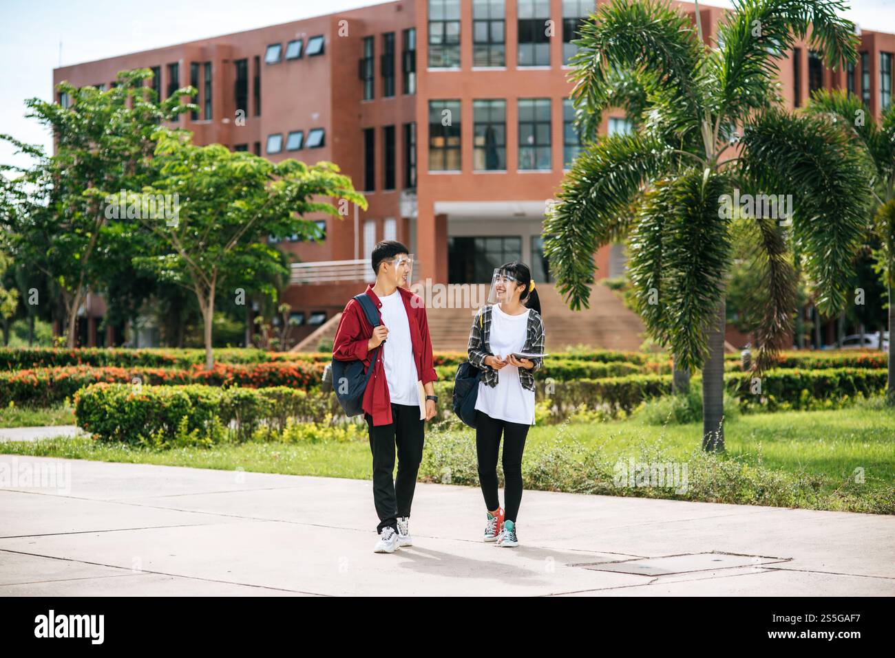 Male and female students wear a face Chill and stand in front of the ...