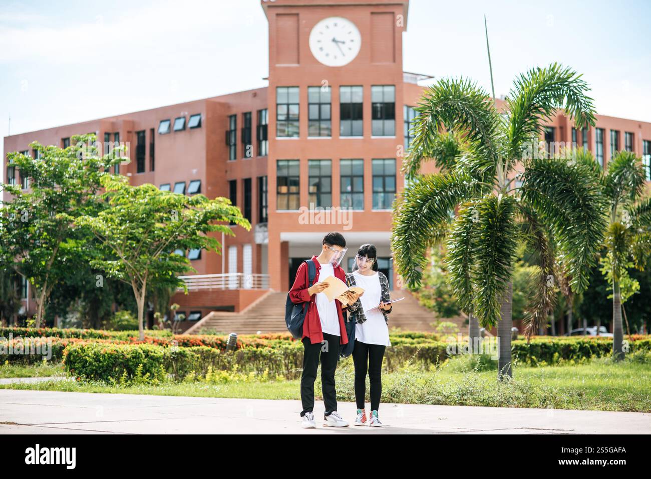 Male and female students wear a face Chill and stand in front of the ...
