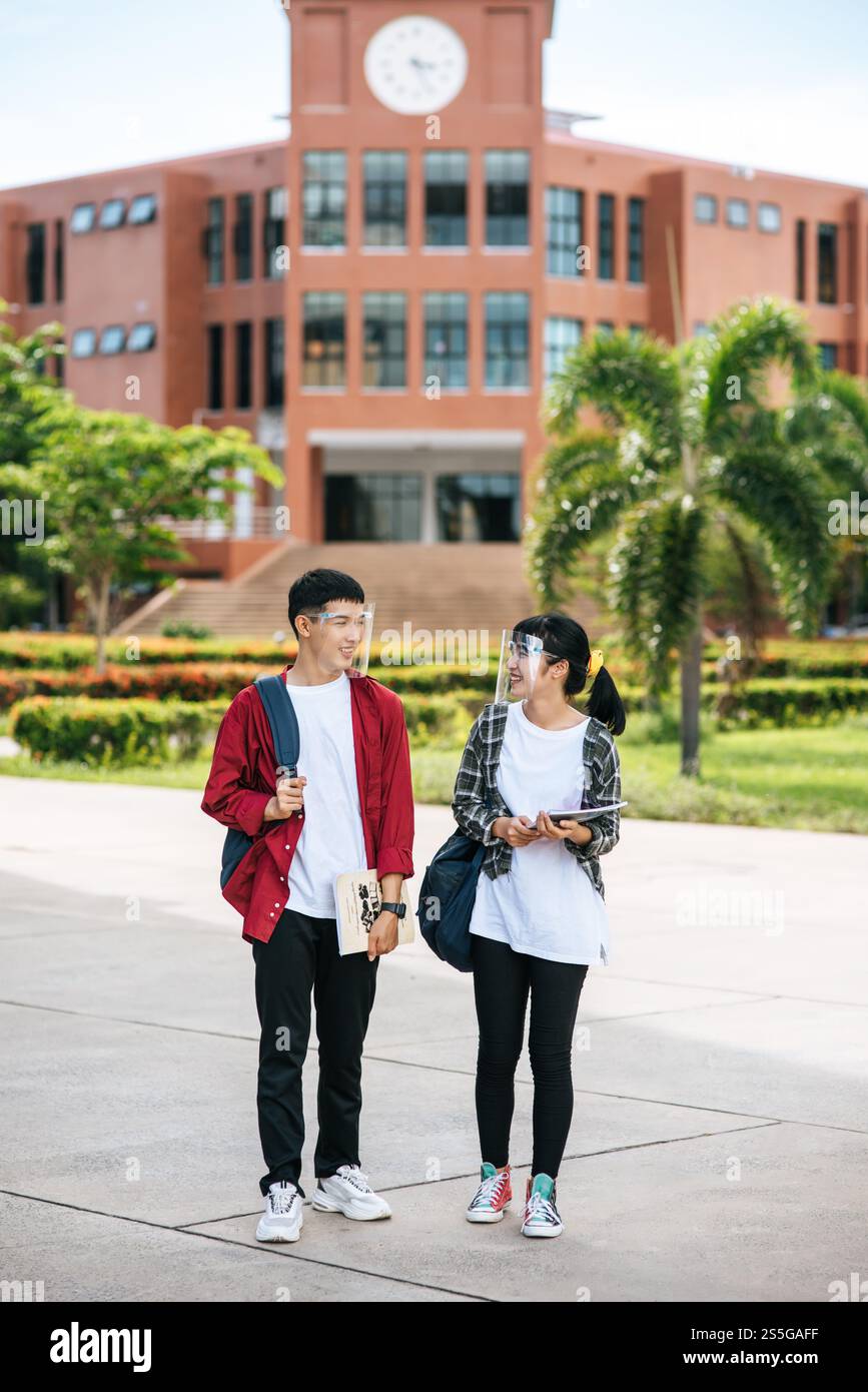 Male and female students wear a face Chill and stand in front of the ...