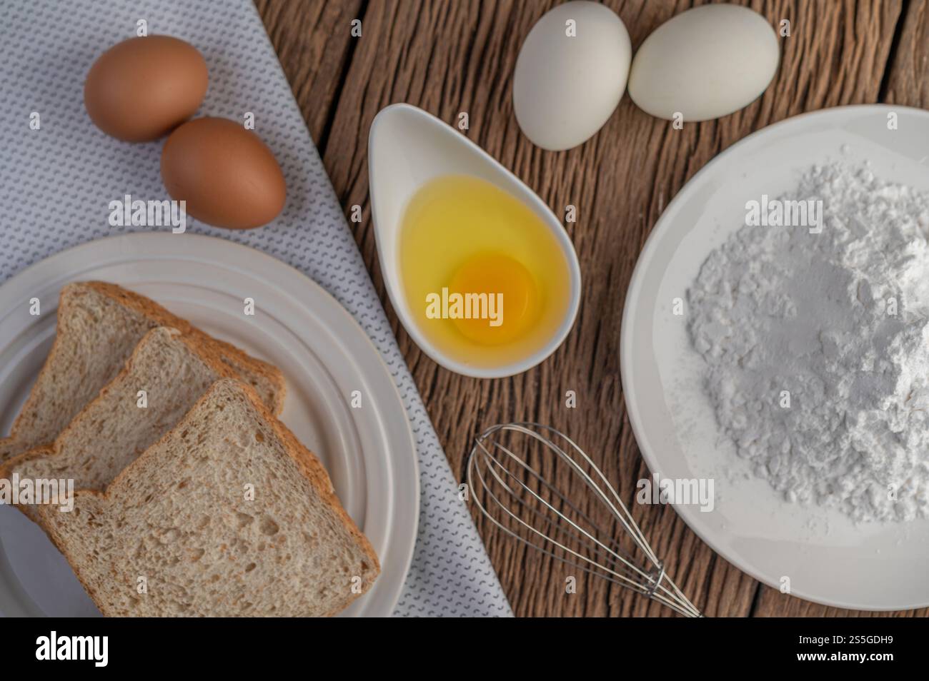 Eggs, bread, tapioca flour and an egg beater, ingredients used in ...