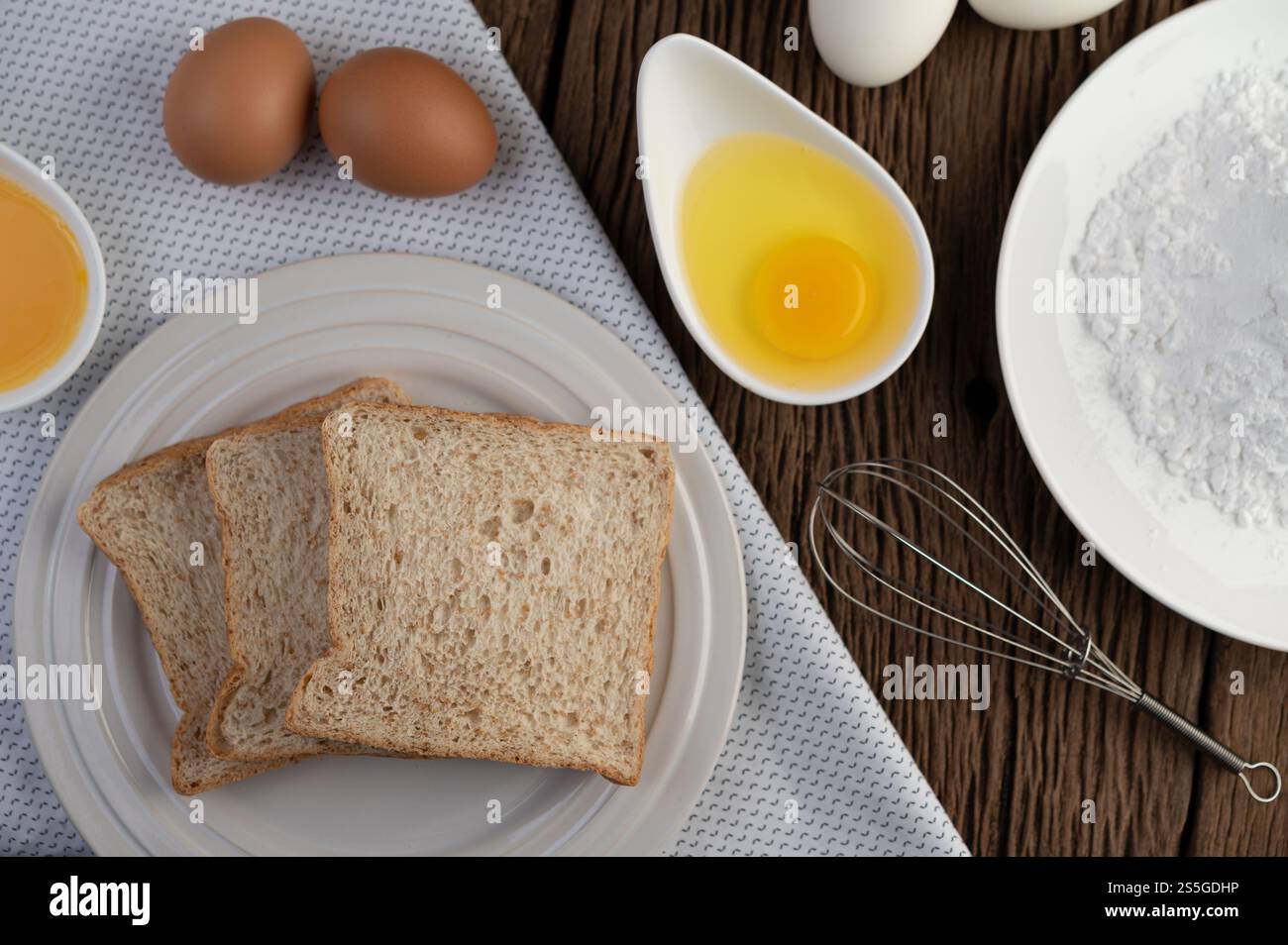 Eggs, bread, tapioca flour and an egg beater, ingredients used in ...