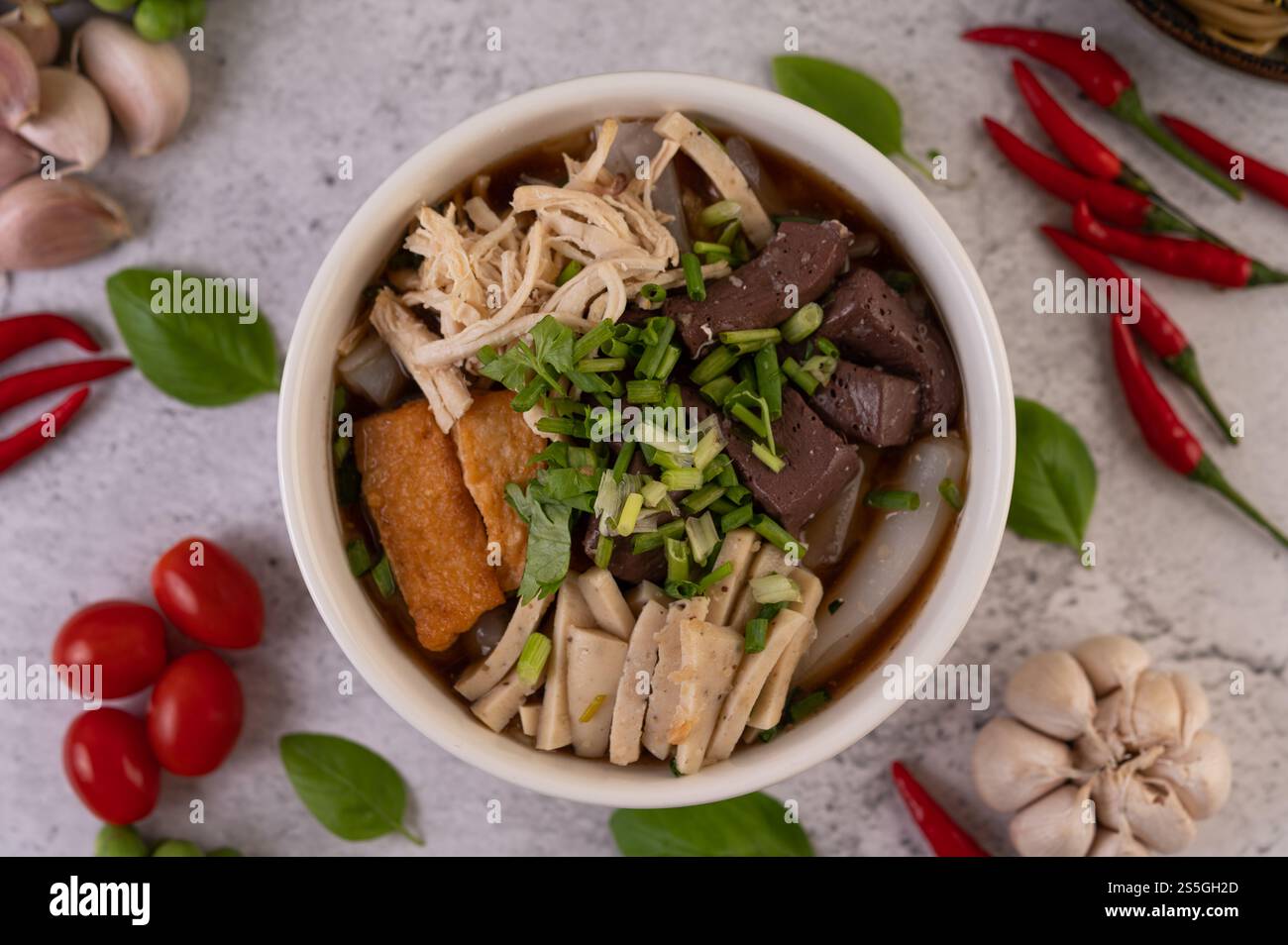 Large noodles with pork blood sausage, shredded chicken, crispy pork ...