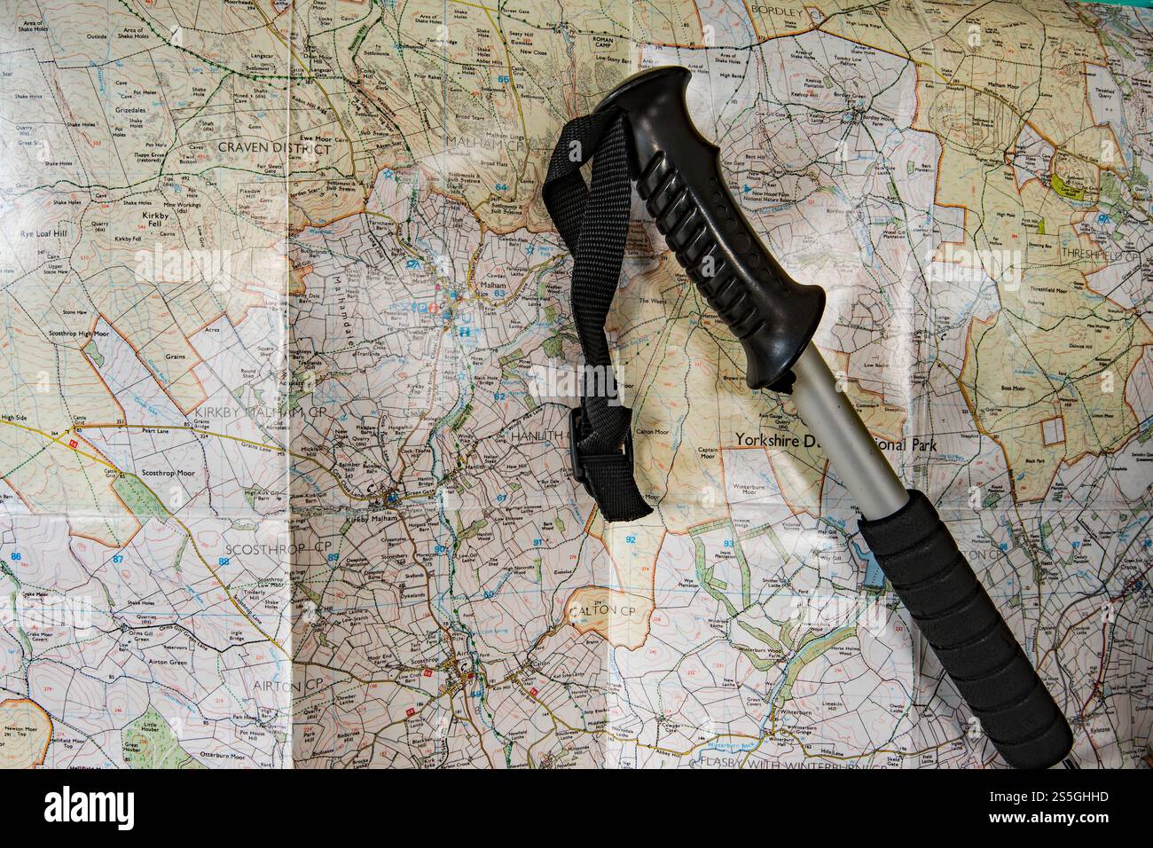 Map with a walking pole laid across the map hi-res stock photography ...