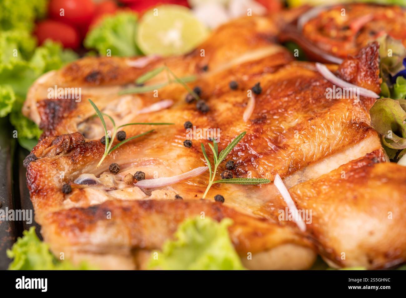 Grilled chicken on the plate with chili Garlic and sprinkled with ...