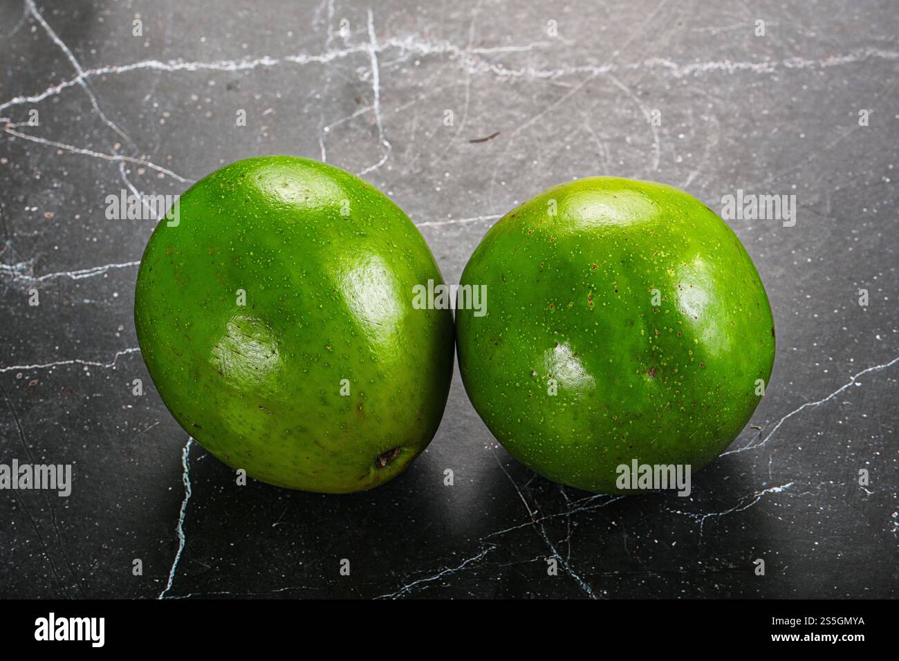 Two ripe green exotic avocado whole fruit Stock Photo - Alamy