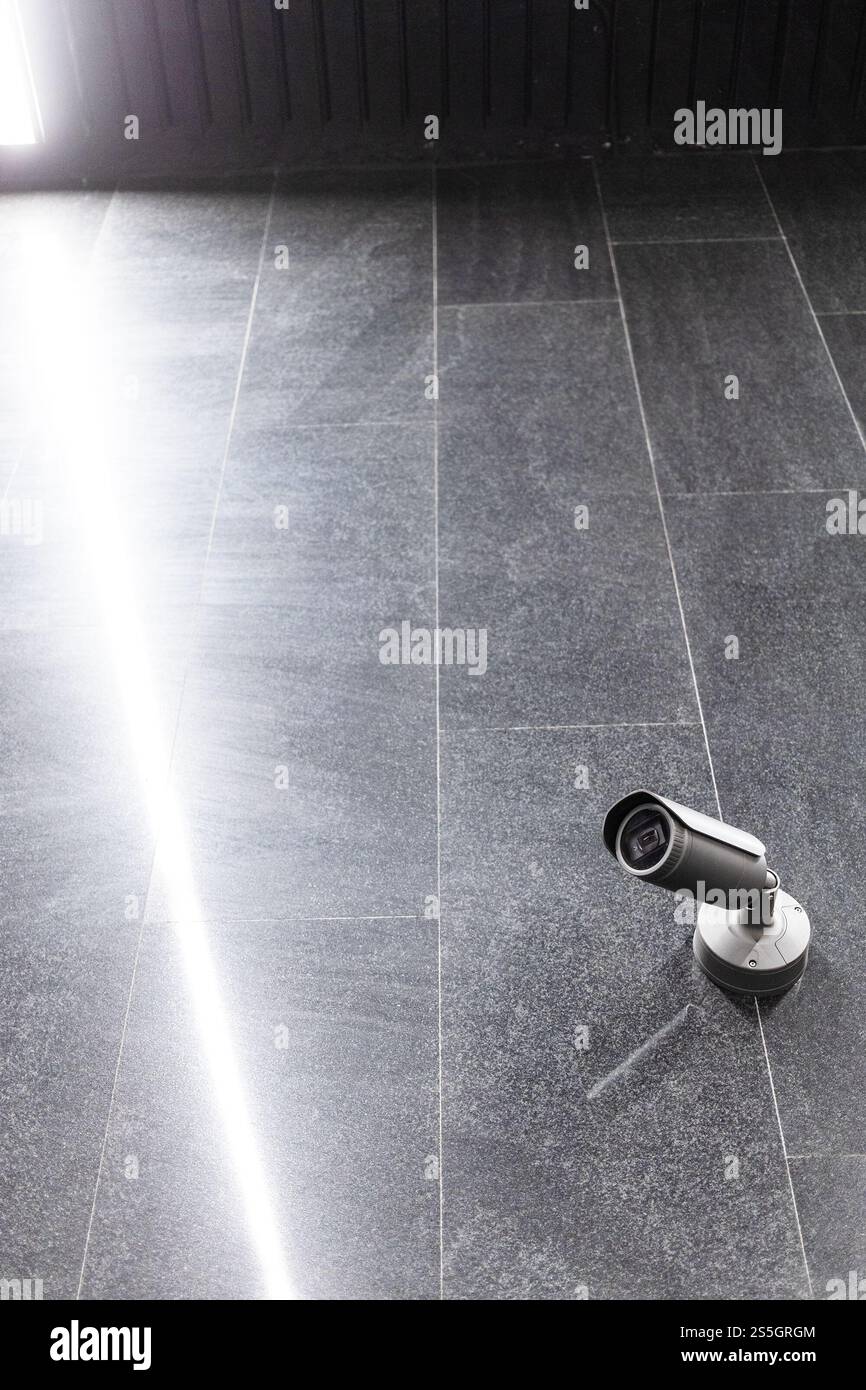 bottom view of surveillance cctv camera on grey granite wall in ...