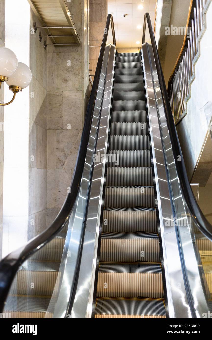 bottom view of indoor moving escalator with steel shiny railings Stock ...