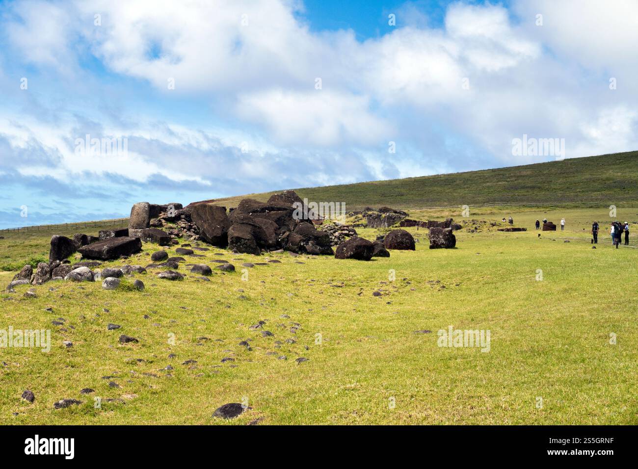 Tourists visit the Ahu Vinapu archaeological site, the Moai remain as ...