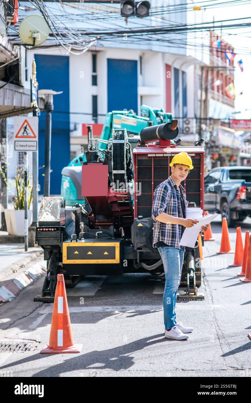 Civil engineers work on large road and machinery conditions Stock Photo ...