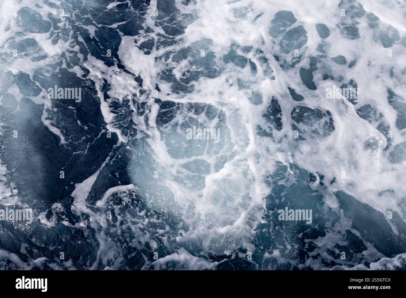 splash of ship water trails cutting through calm sea from top Stock ...