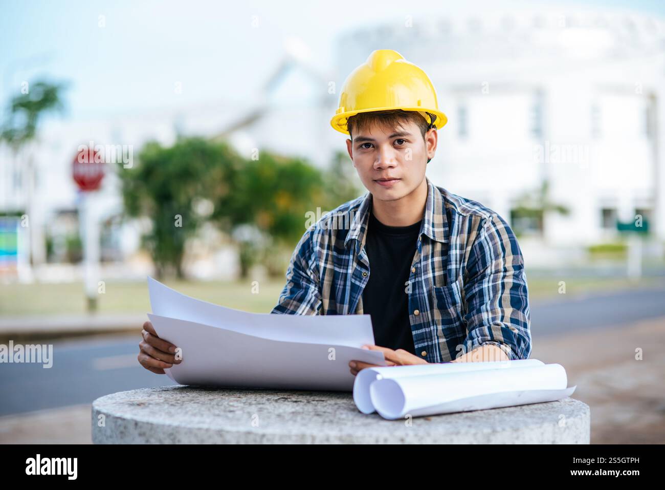 The architect sat and inspected the building plan Stock Photo - Alamy