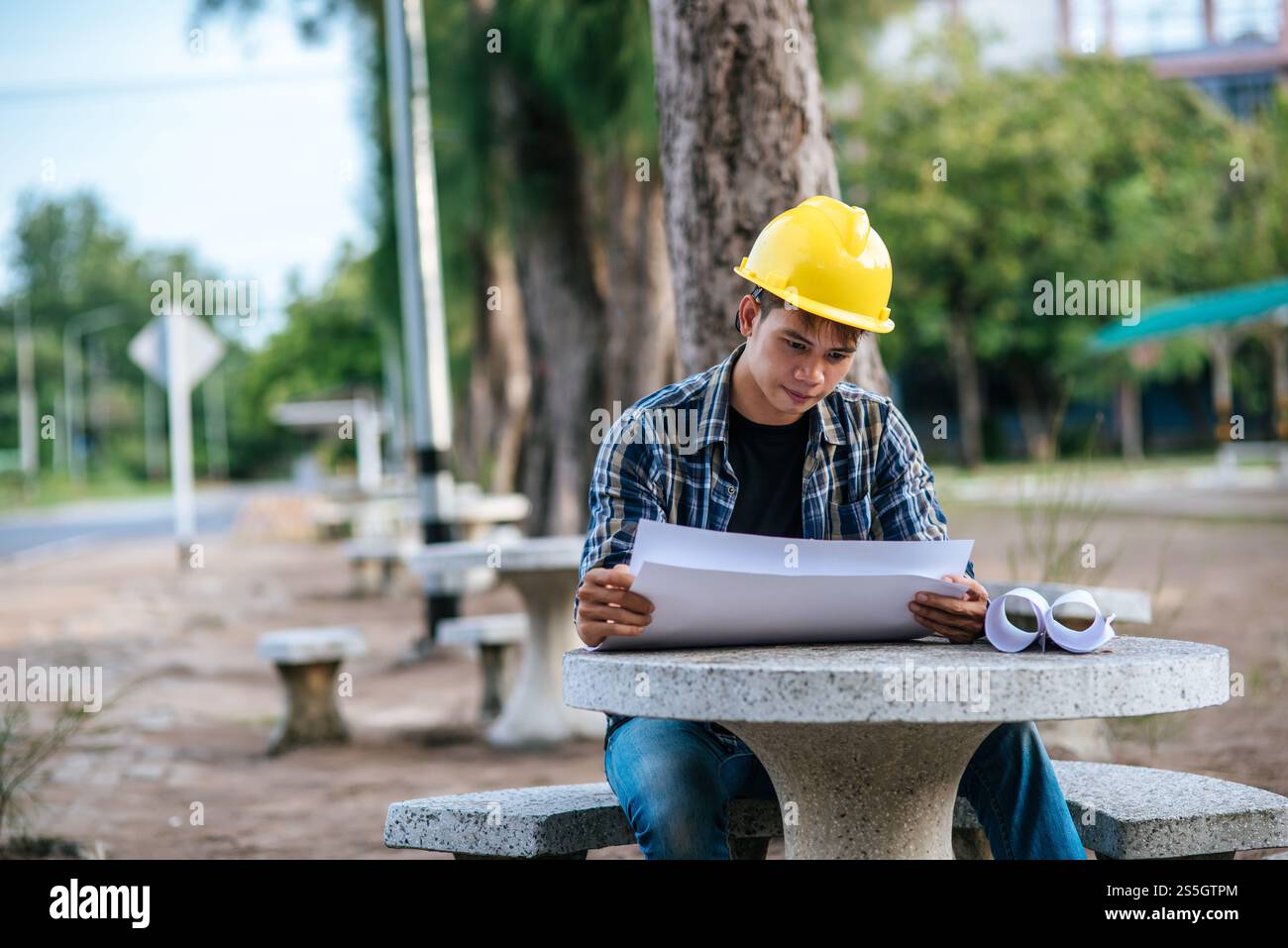 The architect sat and inspected the building plan Stock Photo - Alamy