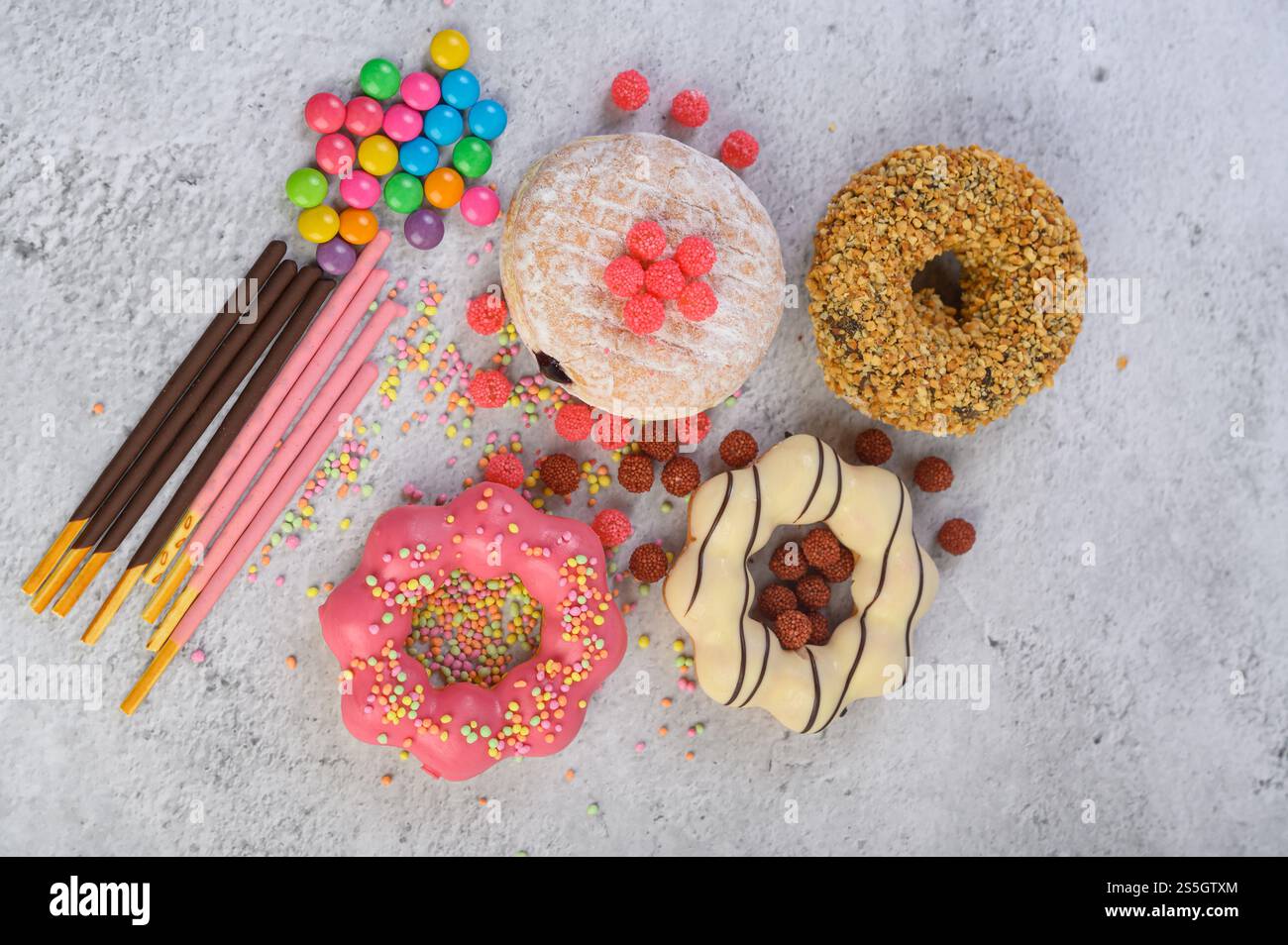 Donuts decorated icing and sprinkles on white background top view Stock ...
