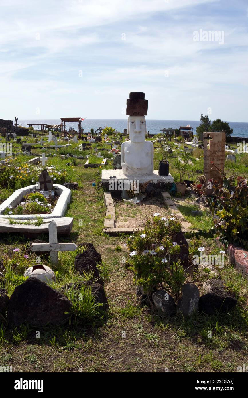 A Moai on a grave in the Hanga Roa cemetery display Christian and ...