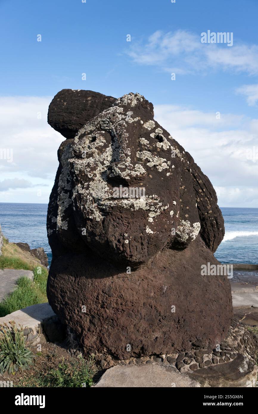 Modern stone statues stand alongside the road into Hanga Roa, Easter ...