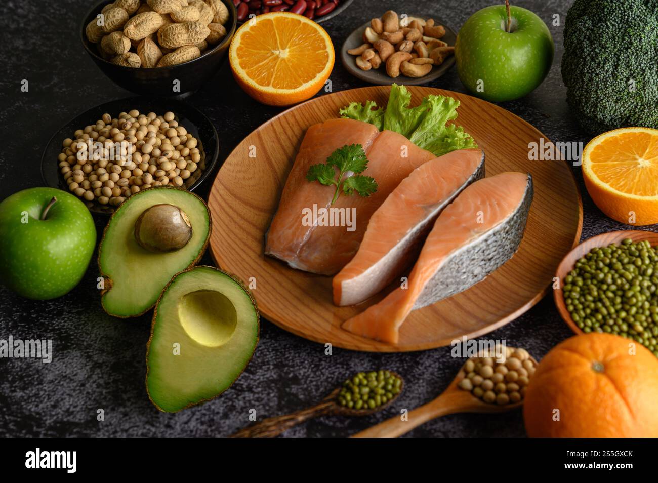 Legumes, fruit and salmon pieces on a wooden plate Stock Photo - Alamy