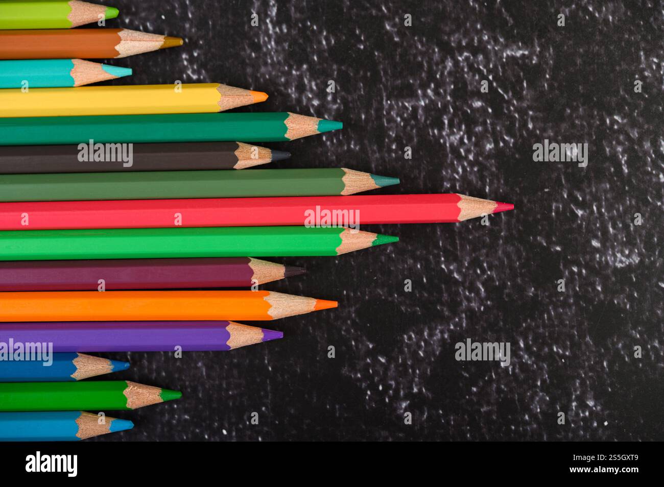colorful crayon pencils with triangle shape on white background with ...