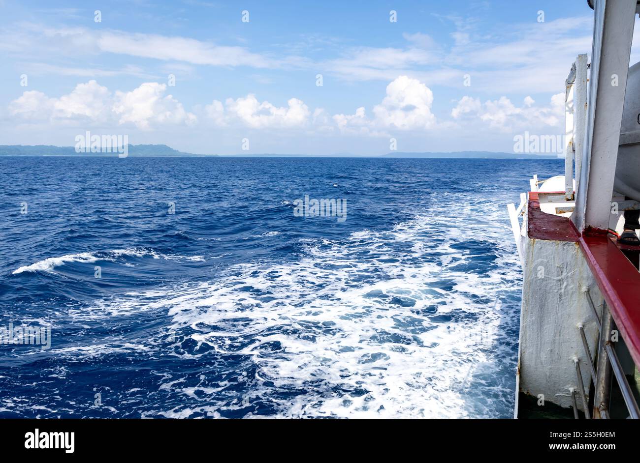 serene sea horizon with ship water trails cutting through sea water ...