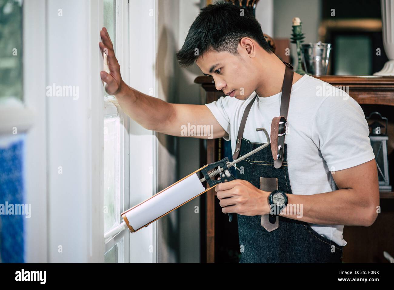 The carpenter holds the glue and attaches to the window. Selective ...