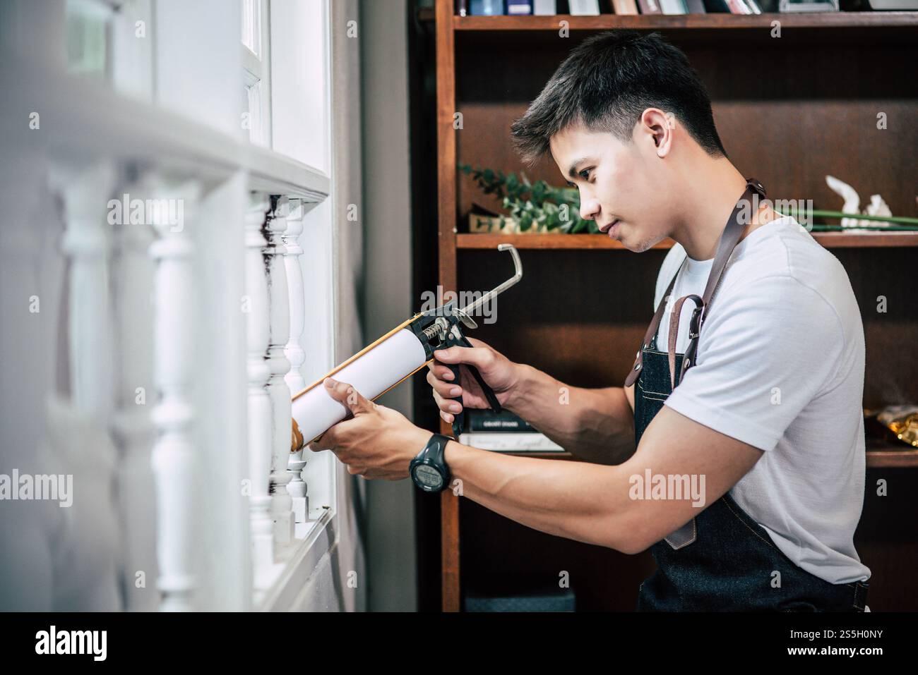 The carpenter holds the glue and attaches to the window. Selective ...