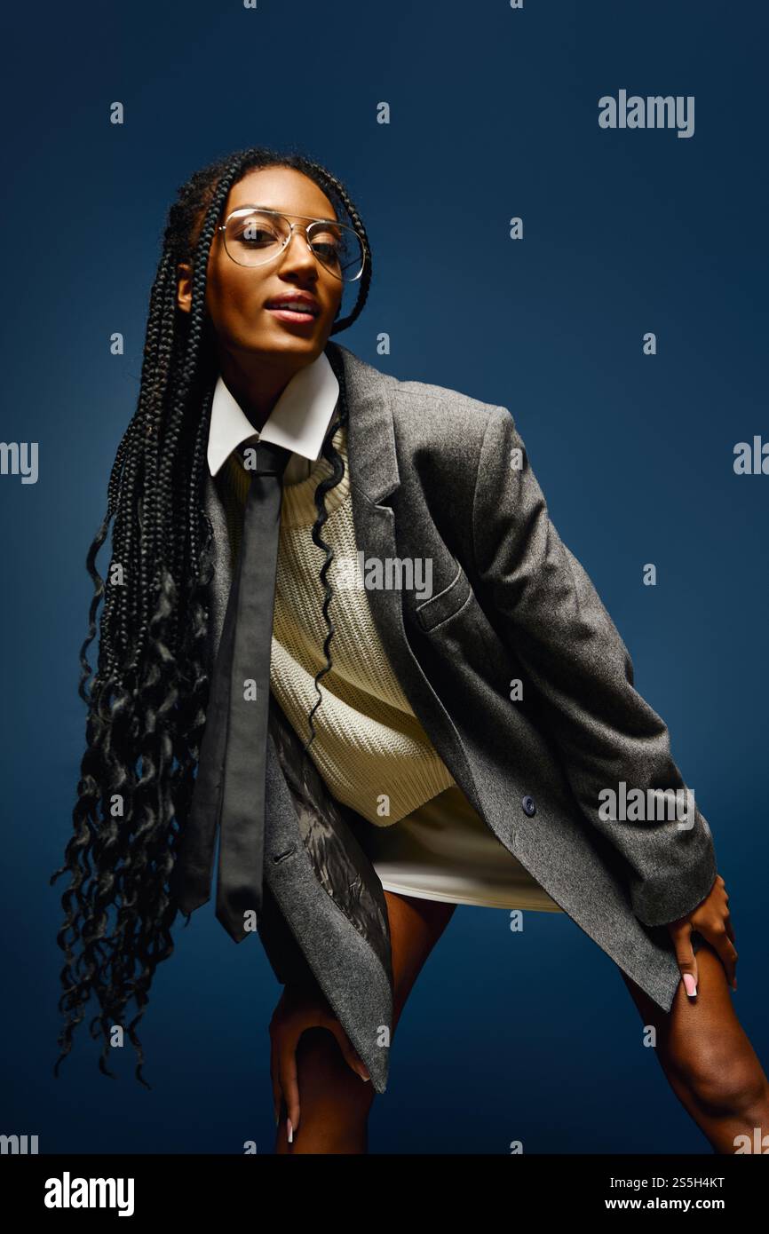 A stylish young woman poses gracefully, effortlessly showcasing her ...
