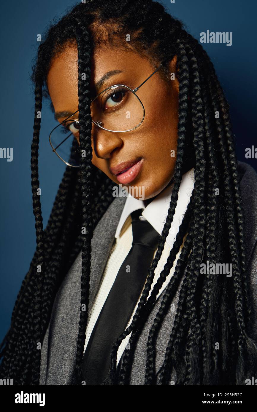 A beautiful young woman with braids is posing confidently, showcasing ...