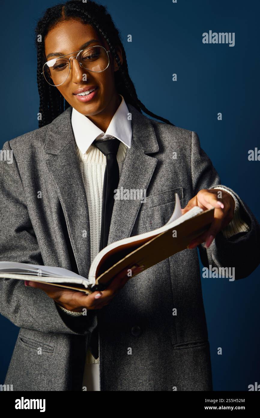 Engaged young woman with glasses flipping through a book, showcasing ...