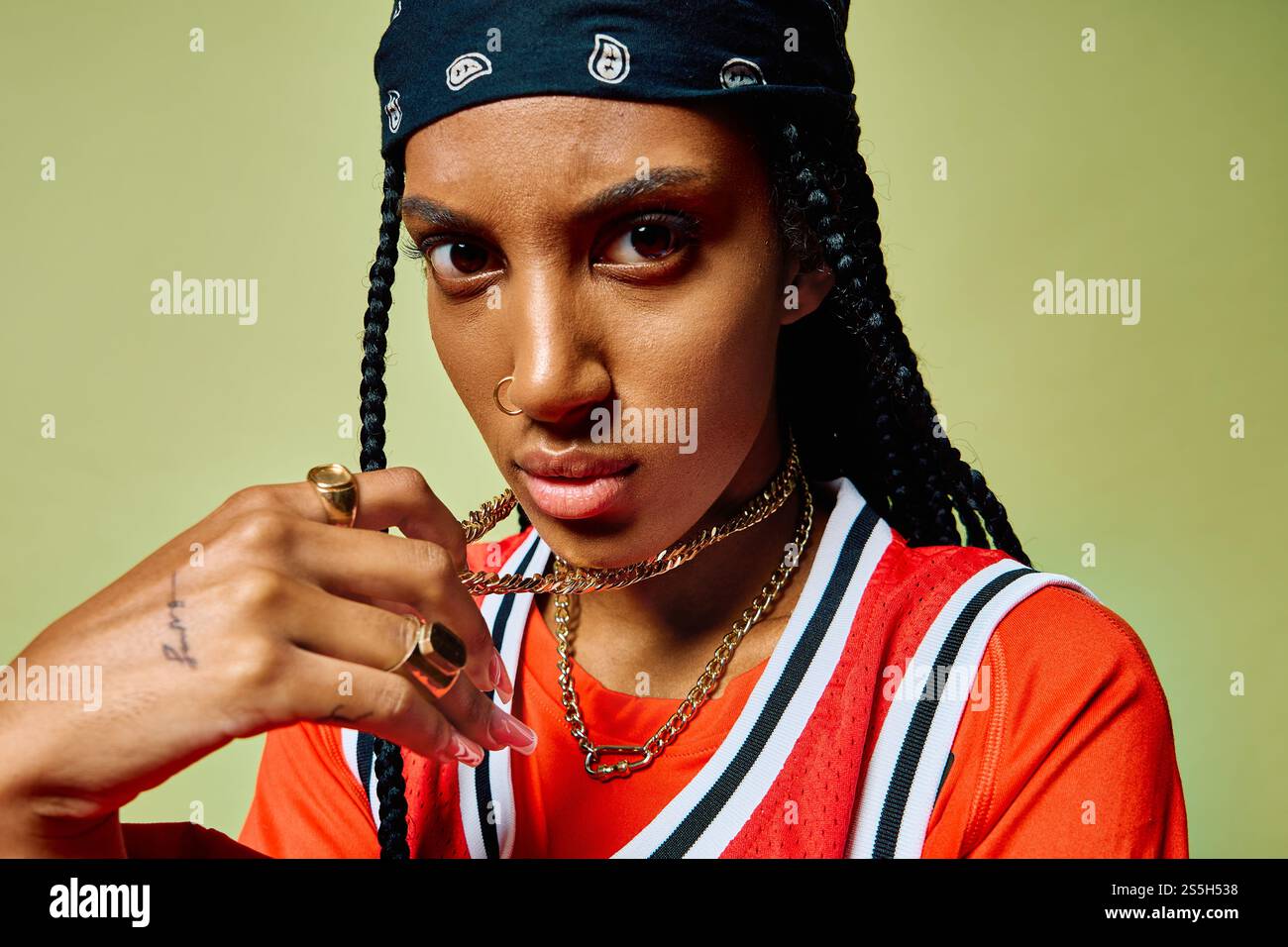 A beautiful young woman showcases her fashion forward look with ...