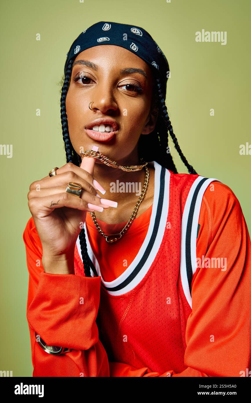 A confident young woman poses with a playful expression, highlighting ...