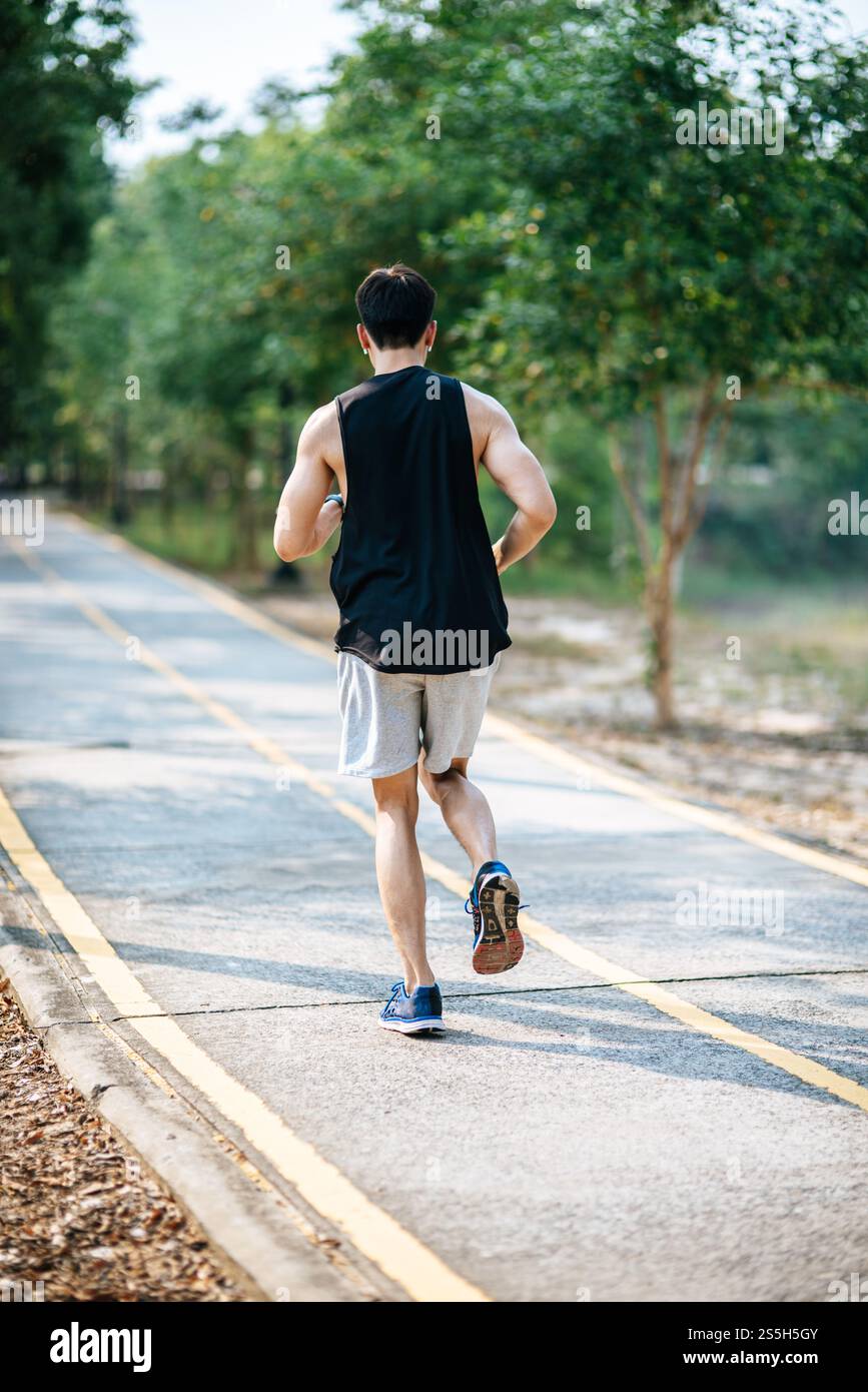 Men and women exercise by running on the road Stock Photo - Alamy