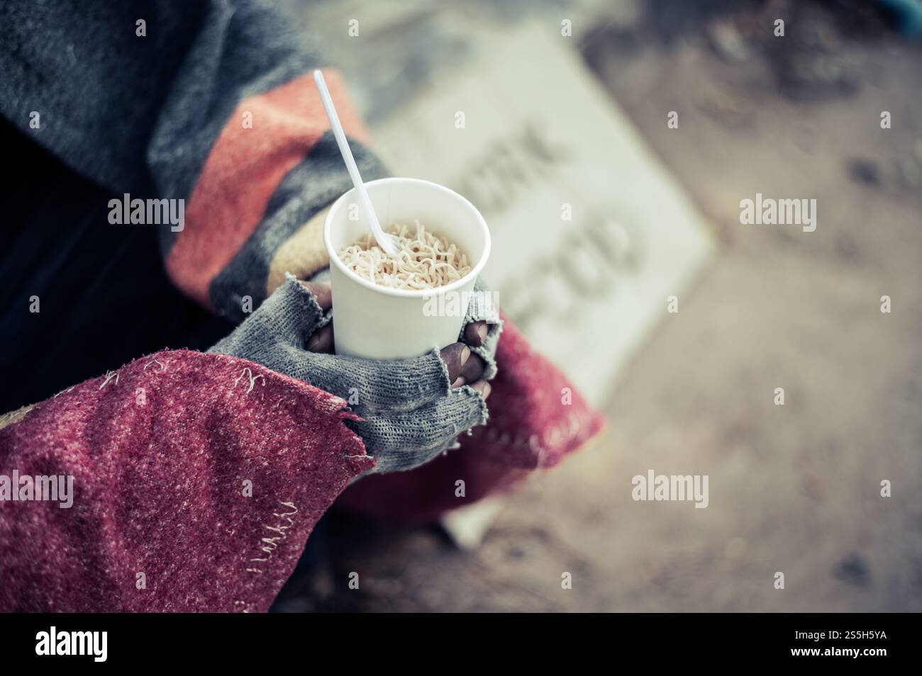 The beggars sat wrapped in cloths and eating noodles Stock Photo - Alamy