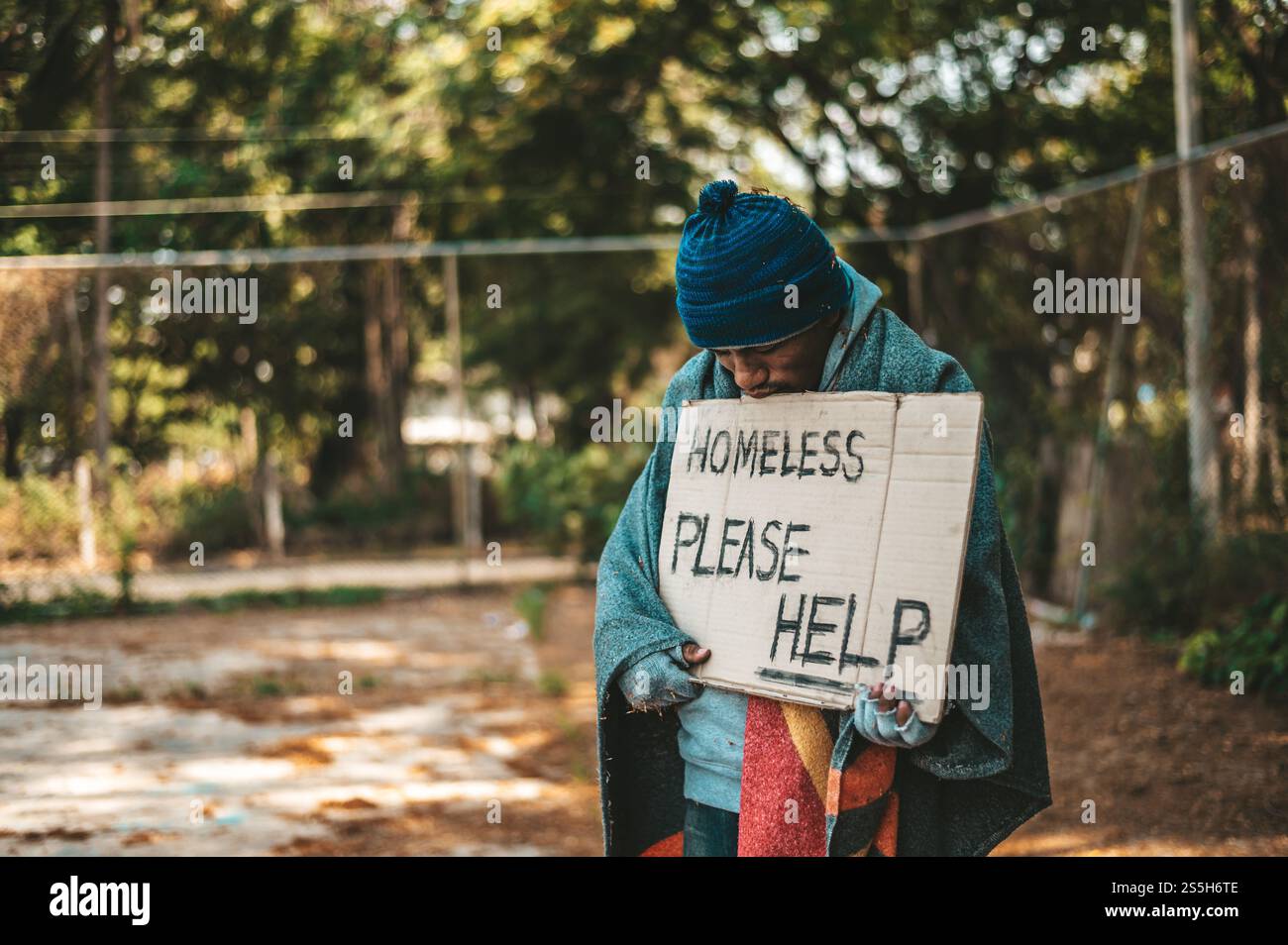 Beggar stand on the street with homeless messages please help Stock ...
