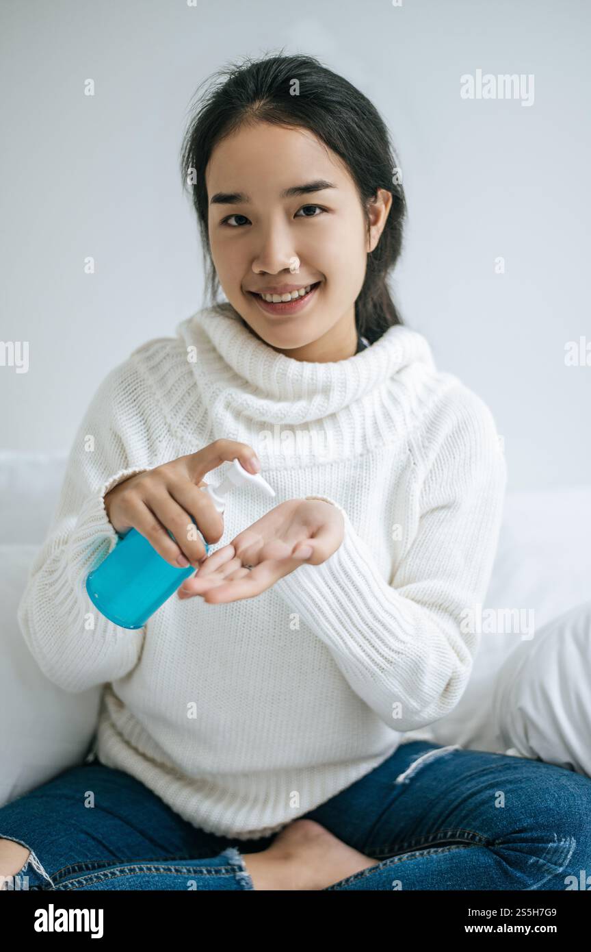 Young women clean their hands with a hand wash gel to prevent germs ... Young women clean their hands with a hand wash gel to prevent germs ...