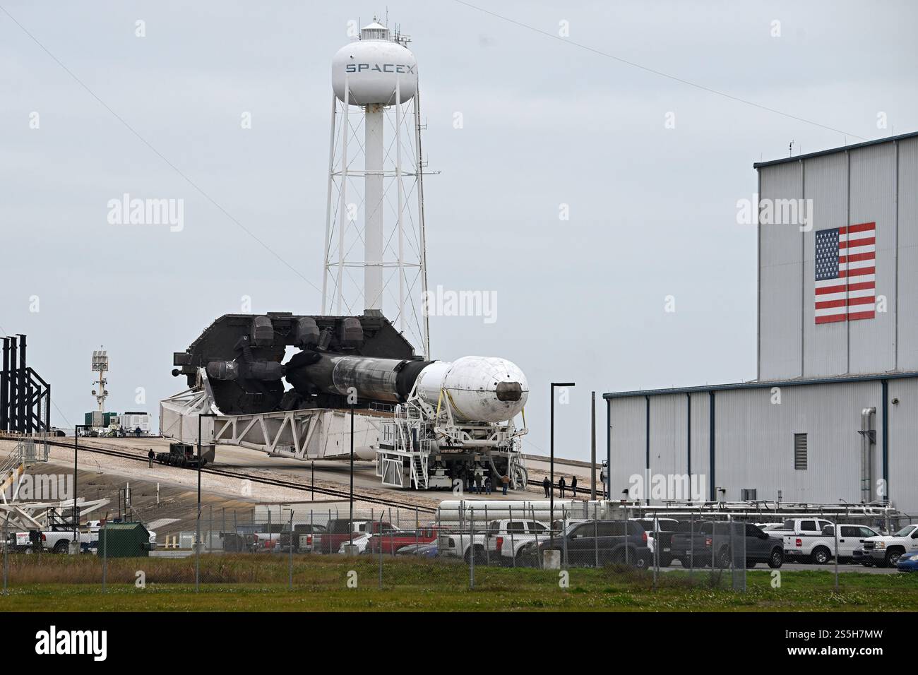 A SpaceX Falcon 9 rocket rolls from its horizontal integration facility to Pad 39A in ...