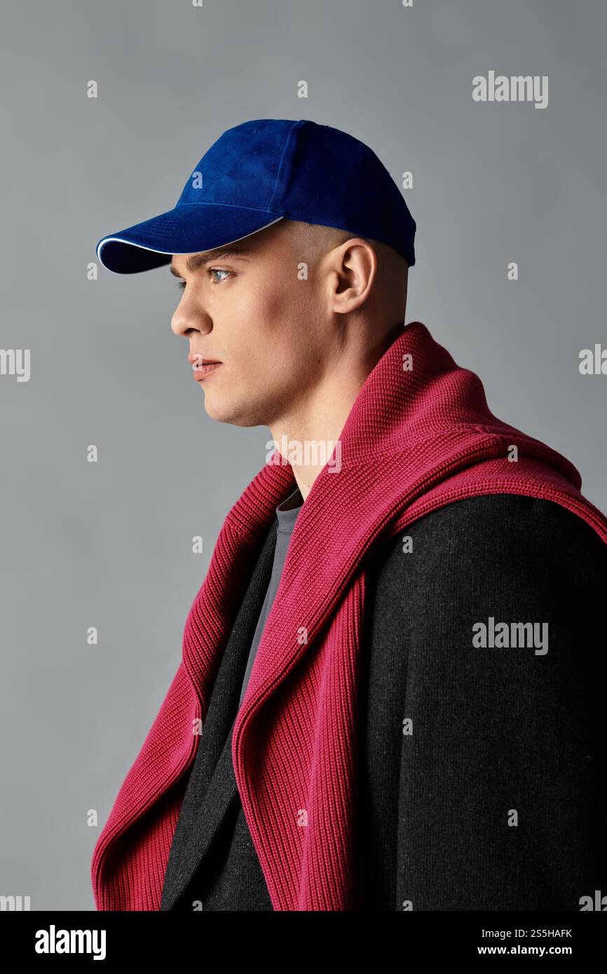 A handsome young man showcases his fashion sense while posing calmly ...