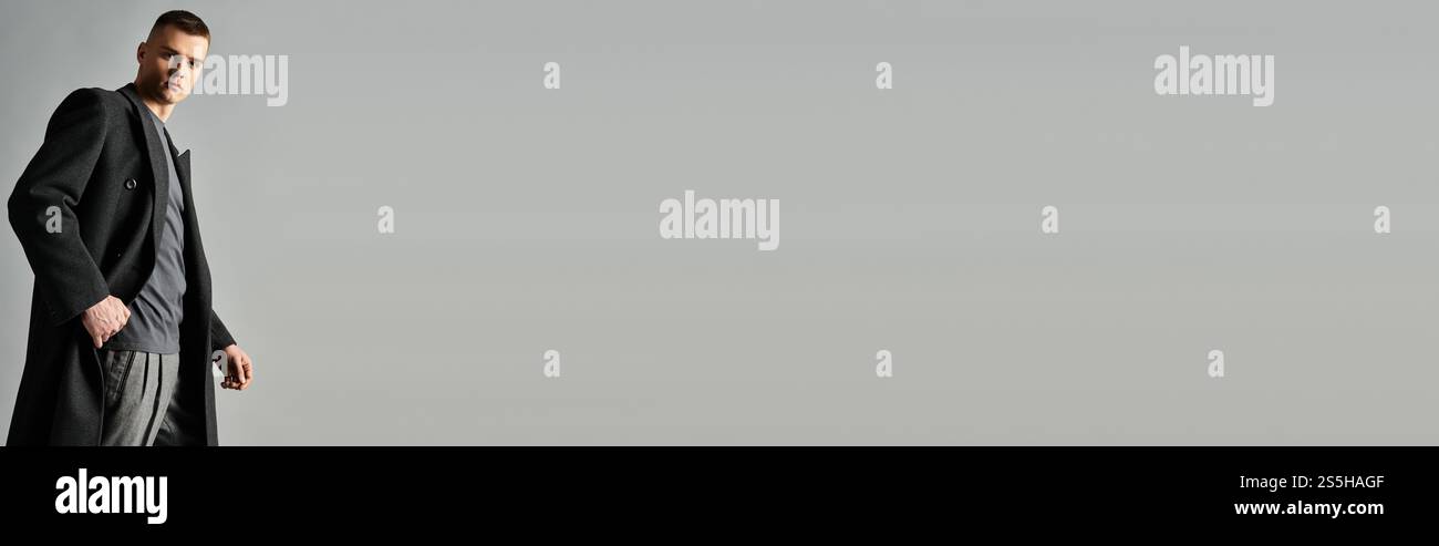 A handsome young man showcases modern fashion with a confident stance ...