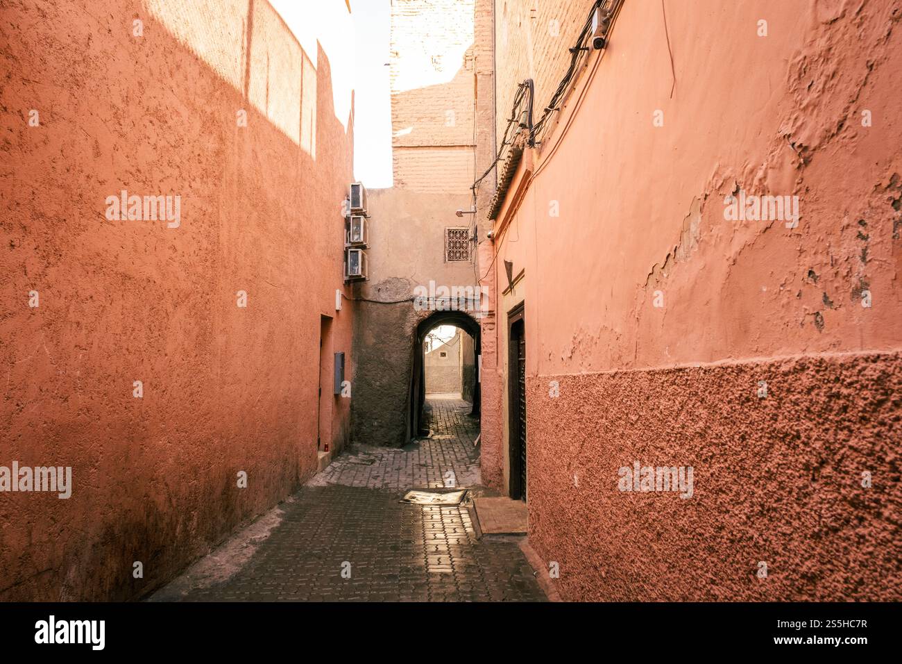 Street alley with pink walls inside the Marrakech Medina in Morocco ...